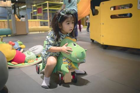 Premium Photo Full Length Of Innocent Girl Sitting On Toy