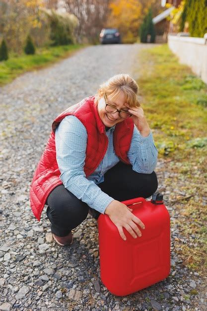 Premium Photo White Woman In Red Vest Holding Red Gasoline Container