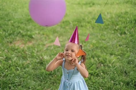 Funny Girl Playing With A Festive Garland Of Colorful Flags And