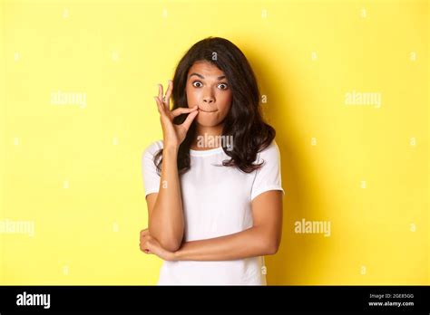 Portrait Of Young African American Woman Making Promise To Keep Secret