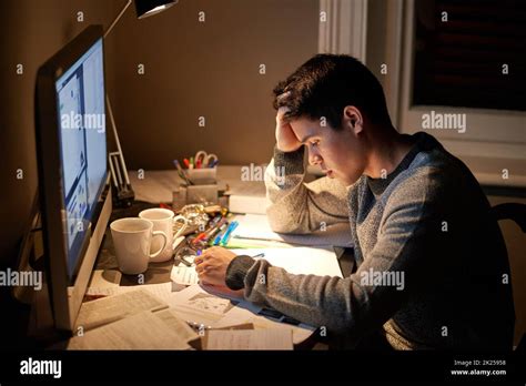 All Night Study Sessions A Young Student Studying Late Into The Night