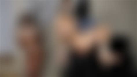 Tethered To A Railing Aspen Rae Stands Naked With Rope Between Her