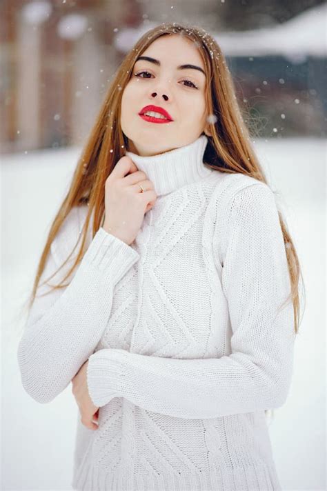 Young Girl In A White Sweater Standing In A Winter Park Stock Image