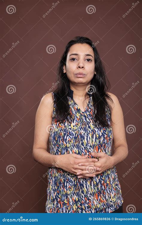 Indian Woman With Neutral Facial Expression Intertwined Fingers