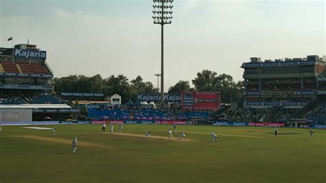 Cricket Match In Progress At A Stadium With Spectators Photo Free Cricket Image On Unsplash