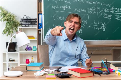 Free Photo Angry Young Male Teacher Wearing Glasses Pointing With