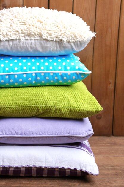 Premium Photo Hill Of Colorful Pillows On Rustic Wooden Background