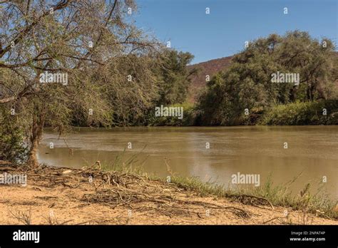 Landscape On The Banks Of The Kunene River The Border River Between