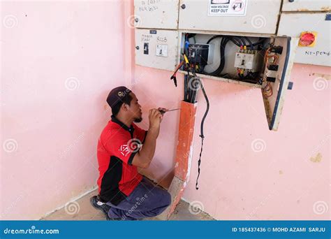 Technician Wiring Cable In Front Of Electrical Panel For Control And Distribute Editorial Photo