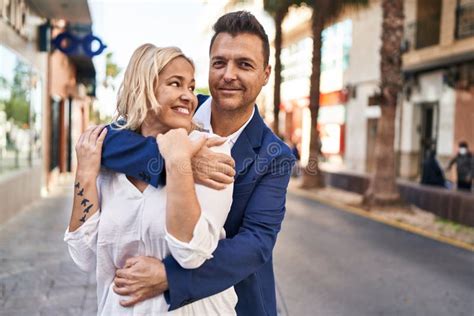 Middle Age Man And Woman Couple Hugging Each Other Standing At Street