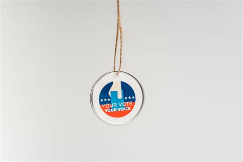 Close Up Of A Pendant With A Text Saying Your Vote Your Voice · Free