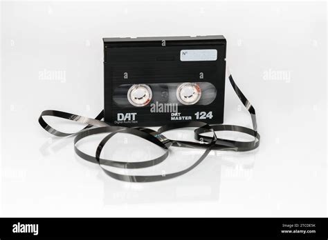 A Dat Digital Audio Tape Cassette With Twisted Tape Stands Upright On