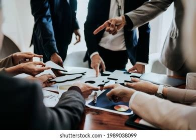 Business People Connecting Puzzle Pieces Together Stock Photo