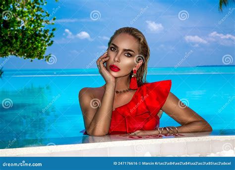 Elegant Tanned Woman In Red Swimsuit In Pool On Tropical Maldives