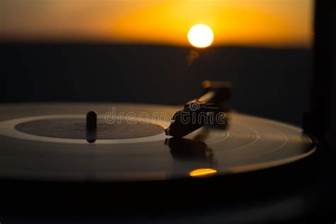 Turntable Vinyl Record Player On The Background Of A Sunset Over The