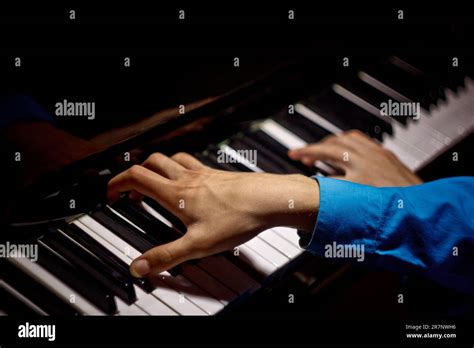 Two Male Hands On The Piano Palms Lie On The Keys Crosswise And Play