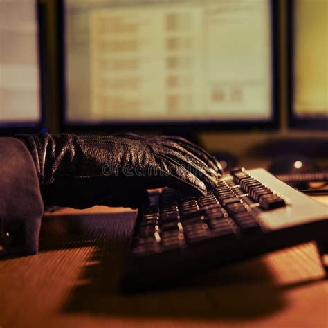 Man Attacker Hacker In Black Gloves On His Hands Working On A Compu