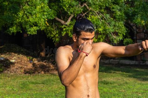 A Young Muscular Athlete Shadow Boxing Outdoors In Park Stock Image