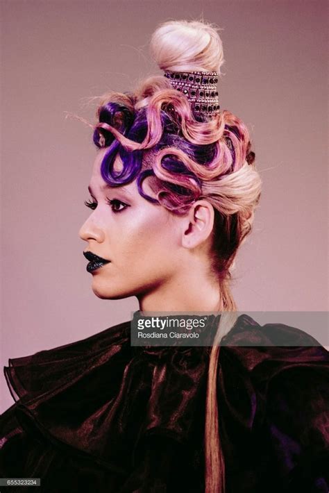 A Model Poses For A Photograph After Having Her Hair Styled And Make Up