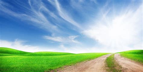 Road Through Grass Field And Clear Blue Sky Stock Photo Image Of Road