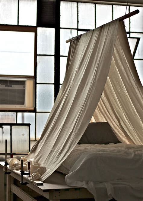 Attic Bedroom With Canopy Bed And Large Windows