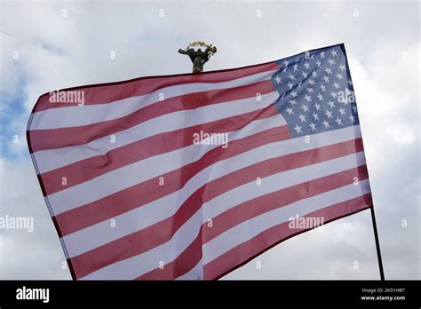 Us Flag Flies In Front Of The Independence Monument During A Rally To Thank Foreign States For