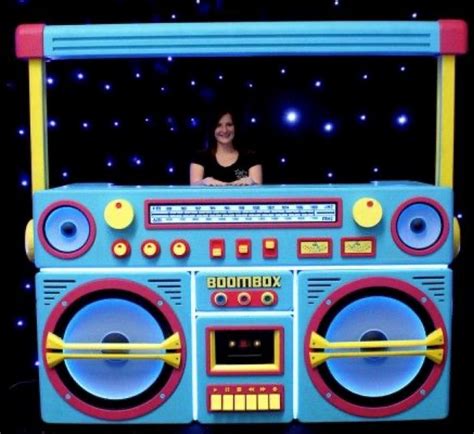 A Woman Is Sitting In Front Of A Boombox With Speakers On It And Lights
