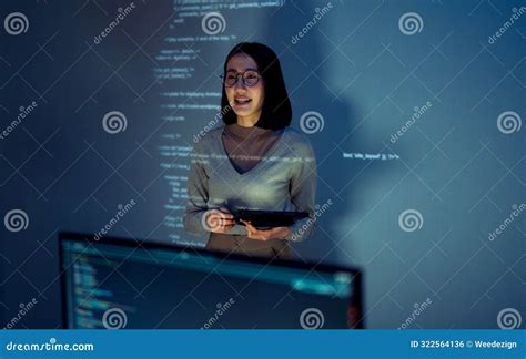 Asian Woman Programmer Standing In Front Of A Screen With Code