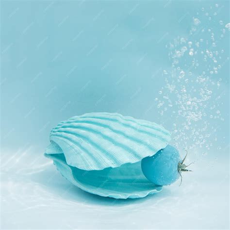 Premium Photo Blue Sea Shell And Tomato With Air Bubbles In The Water Summer Minimal Concept