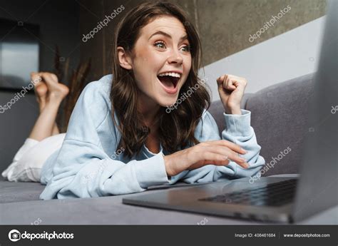 Image Excited Woman Making Winner Gesture Working Laptop While Lying