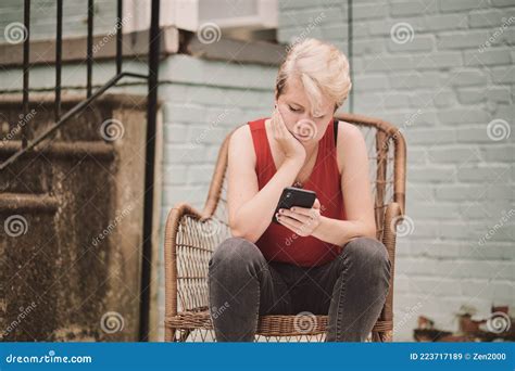 Non Binary Gender Millennial Person Sitting In Chair Stock Image