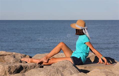 Chica Con Sombrero De Paja En Las Rocas Junto Al Mar Foto De Archivo