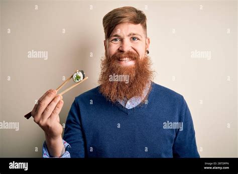 Redhead Irish Man With Beard Eating Green Maki Sushi Using Chopsticks
