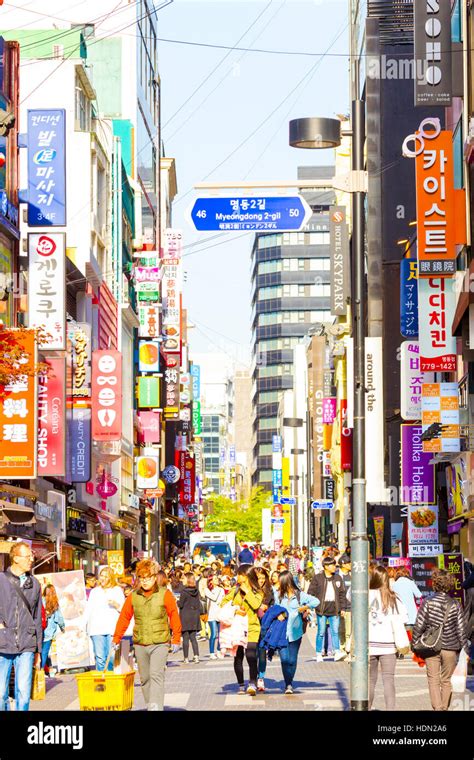 Tourists Walking Down Bustling Myeongdong Pedestrian Shopping Street