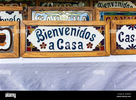 Welcome Home Colorful Sign Written In Spanish That Says Bienvenidos A Casa At Sale In A Street