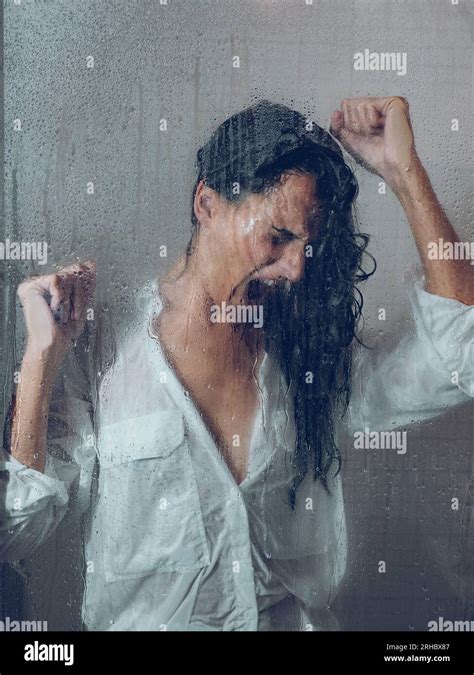 Through Glass Of Mad Young Ethnic Female With Long Dark Wet Hair In