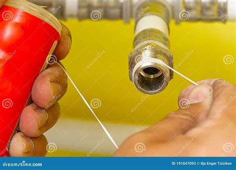 Worker Installing Sealing Tape For Water Pipe Fitting Plumber Putting