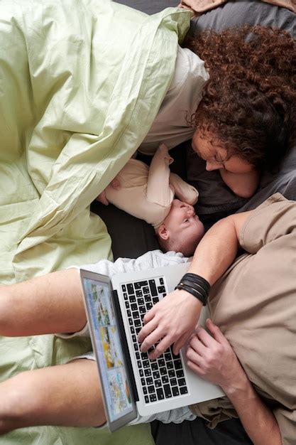 Premium Photo Above Angle Of Man Typing On Laptop Keyboard Next To His Wife And Baby Son