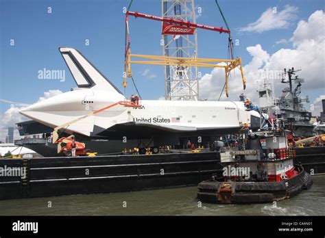 Space Shuttle Enterprise Being Lifted By A Crane To The Intrepid Flight