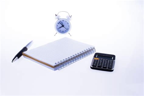 Premium Photo Notebook Alarm Clock Calculator And Pen