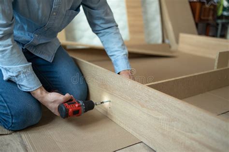 Close Up Of A Man S Hands Assembling A Wooden Bed A Man Is Using An