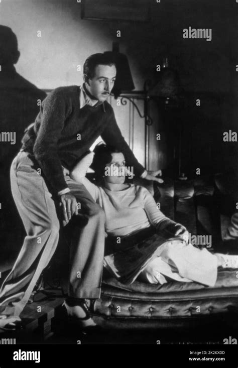 American Animator And Producer Walt Disney Stands Behind His Wife Lillian Bounds As She Sits