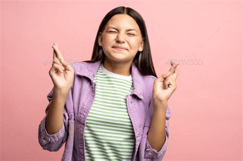 Dreaming Smiling Teenage Girl Making Wish Crossing Fingers With Closed