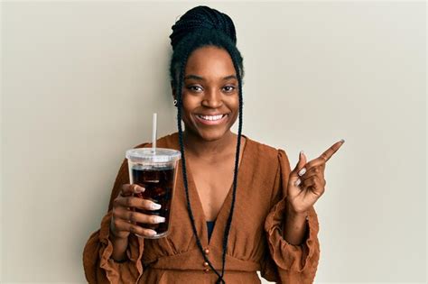 Free Photo African American Woman With Braided Hair Drinking Glass Of