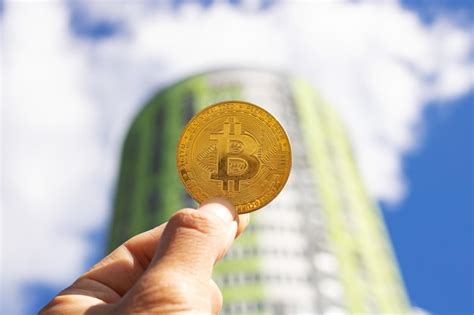 Premium Photo Bitcoin On Backdrop Of Modern Tall Building