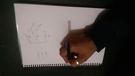 In the circuit shown in fig C1 6μF C2 3μF and battery B 20 V The swit