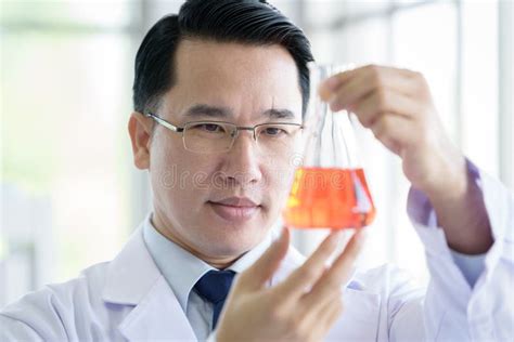 Asian Laboratory Scientist Man Working At Lab With Test Tubes Stock