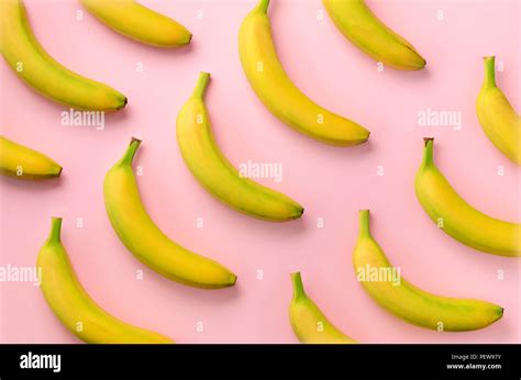 Colorful Fruit Pattern Bananas Over Pink Background Top View Pop Art