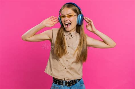 Happy Young Woman In Headphones Listening Music Dancing Disco Having