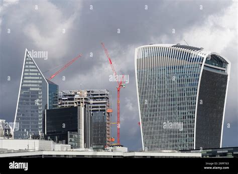 a view across the thames of the tower blocks and ongoing construction